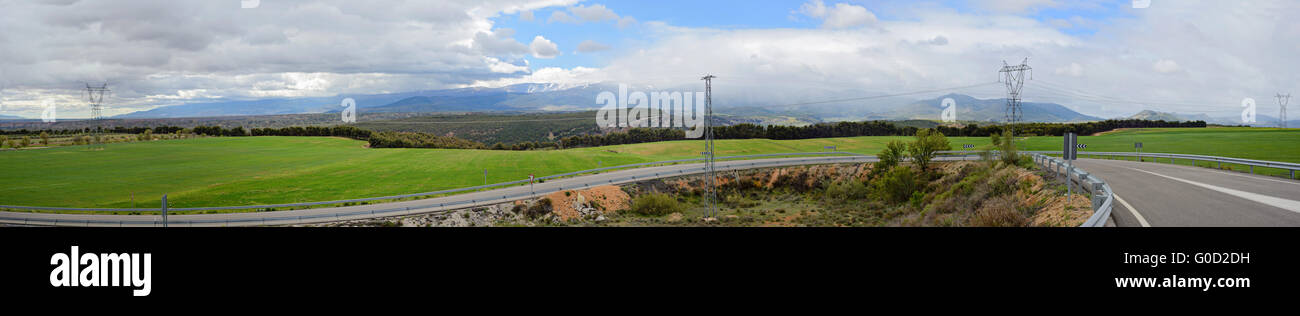 Panoramic view with road, mountains and cloudscape Stock Photo - Alamy