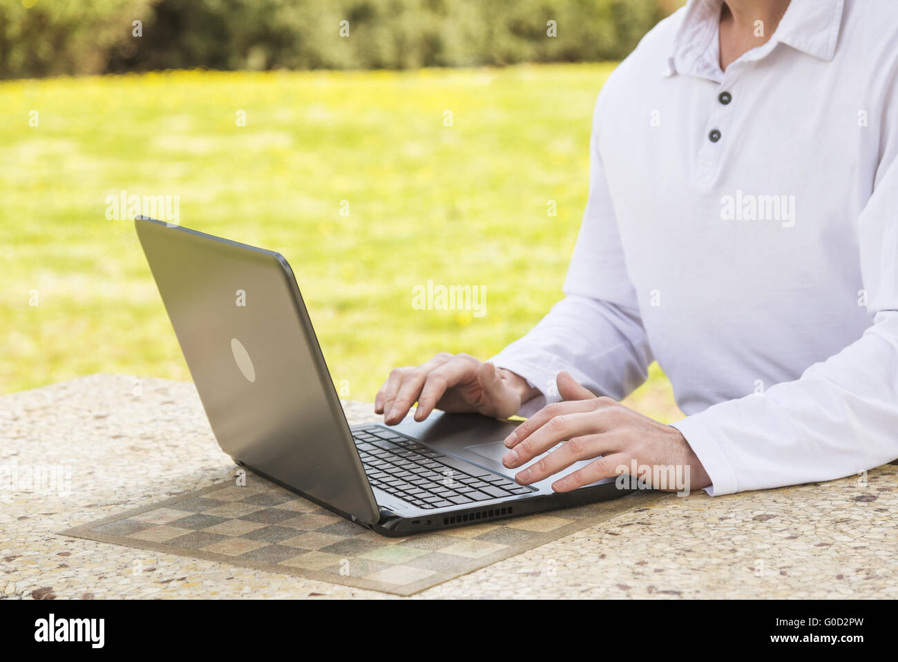 Man working with laptop outdoors Stock Photo - Alamy