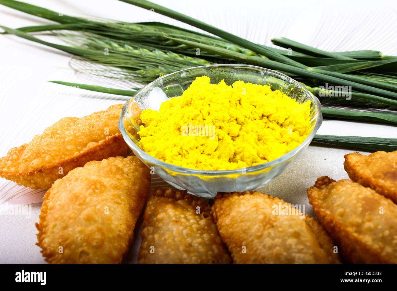 gujia in plate with holi green color in bowl Stock Photo - Alamy