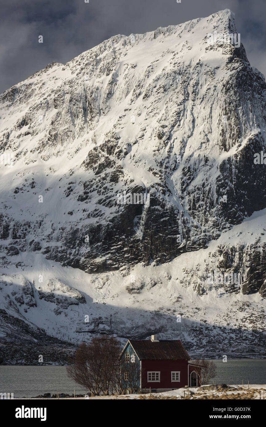 house at fjord and tall rock wall, Lofoten, Norway Stock Photo - Alamy