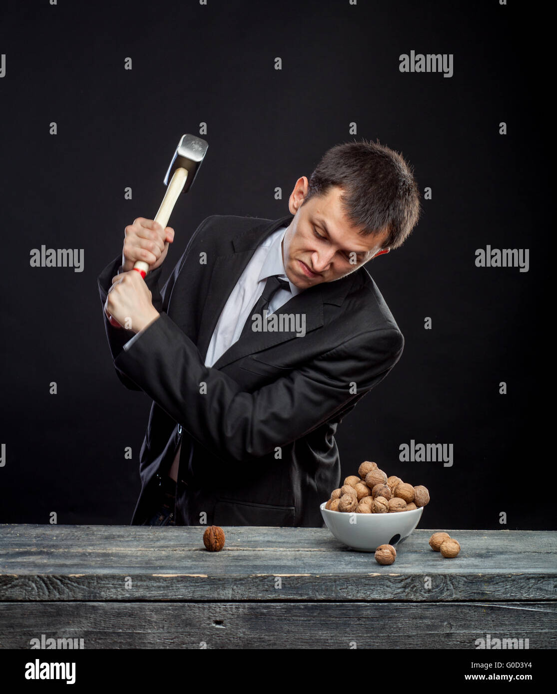 young man stabs a nut Stock Photo - Alamy