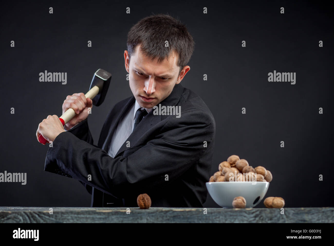 young man stabs a nut Stock Photo - Alamy