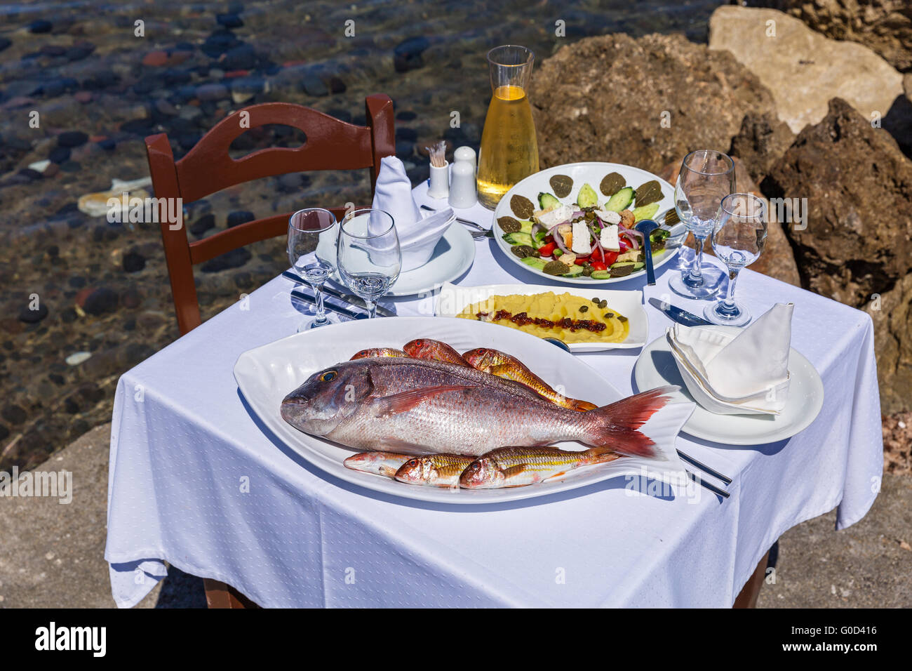 Table to dinner Navy pier, and the choice of fish for cooking Stock ...