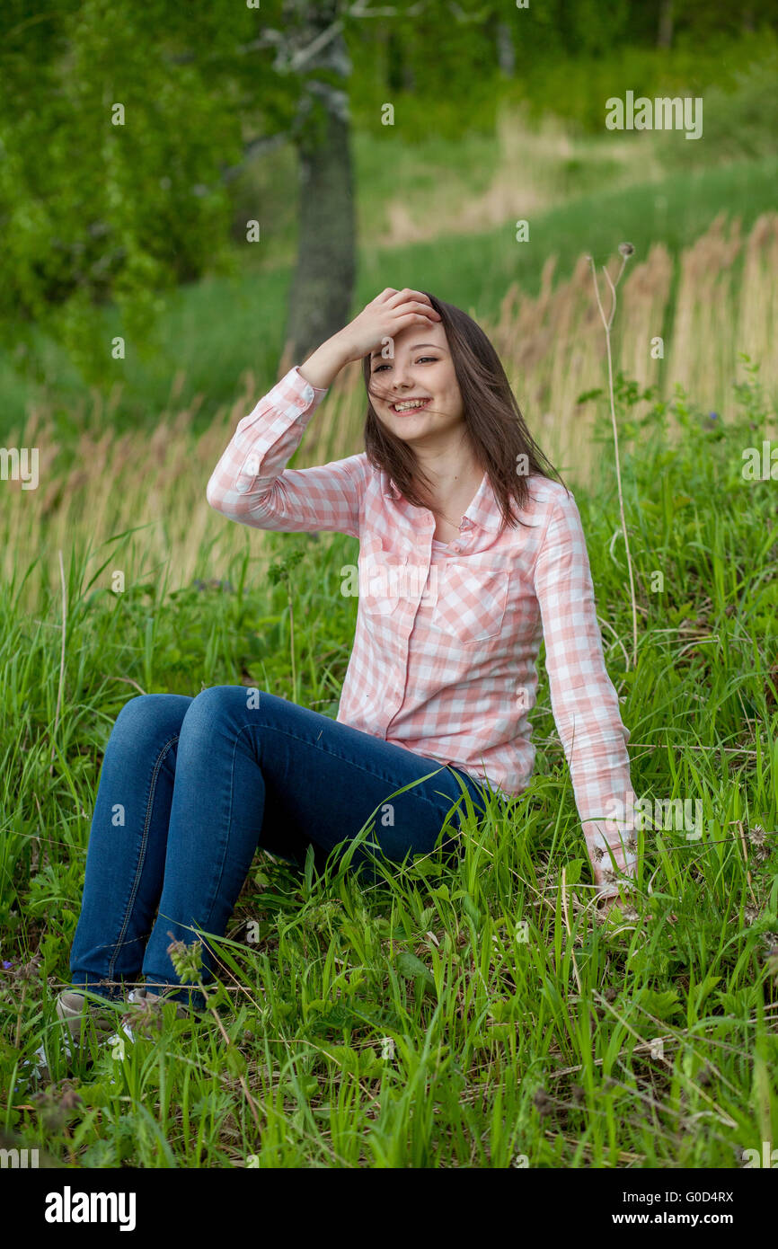 girl sitting on the field Stock Photo - Alamy