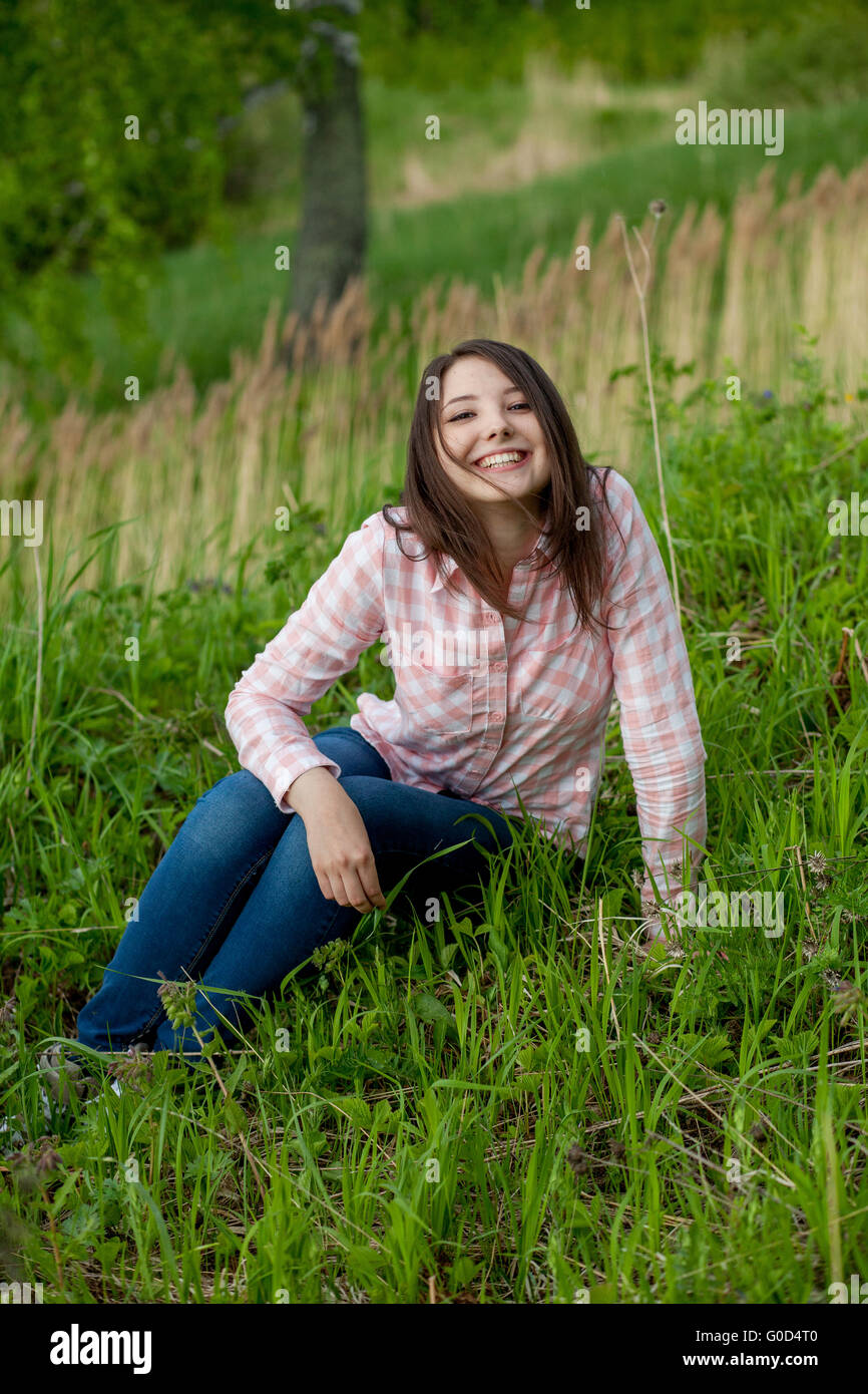 girl sitting on the field Stock Photo - Alamy