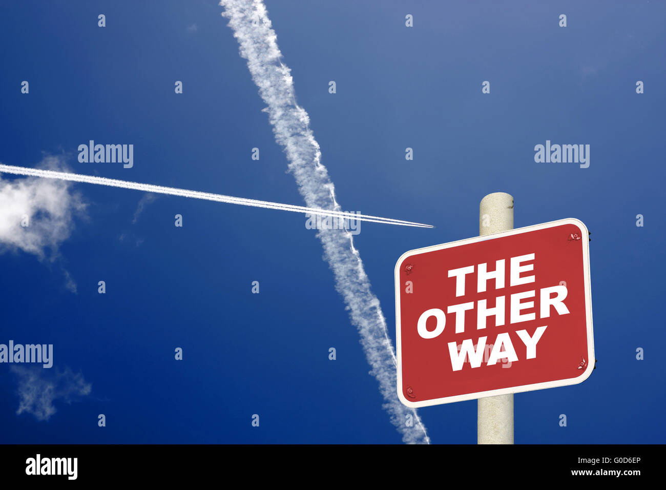 The other way sign with jet trails crossing a blue sky Stock Photo - Alamy