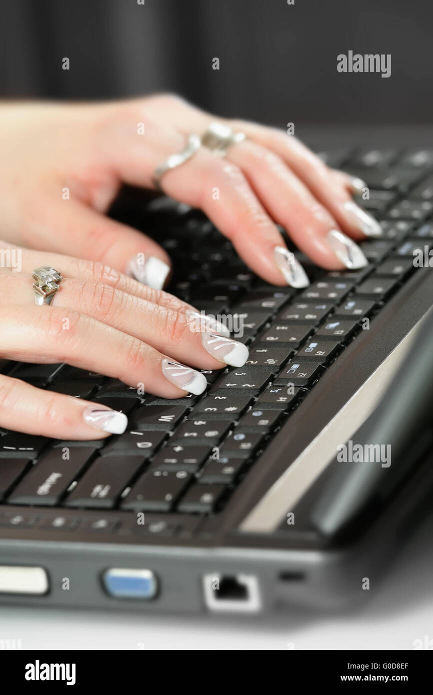 Female's hand with white nails touching a black metal keyboard Stock ...