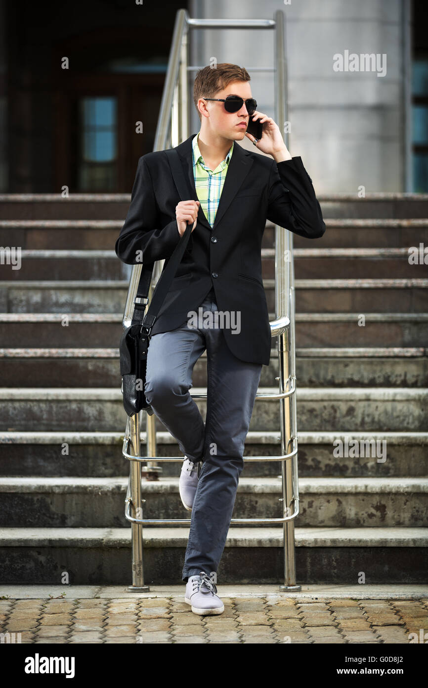 Young man calling on the mobile phone outdoor Stock Photo - Alamy