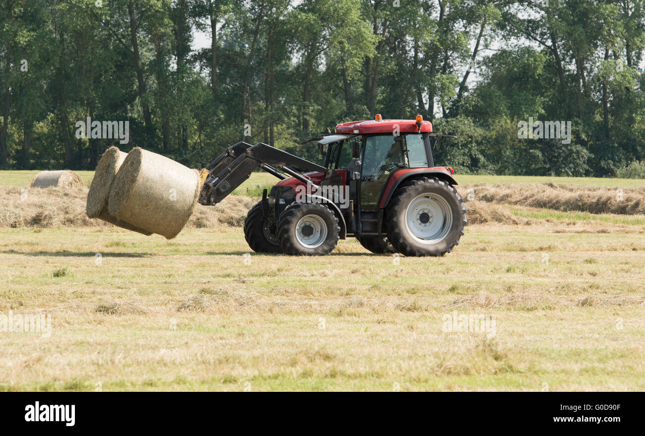 Round baler in haymaking Stock Photo - Alamy