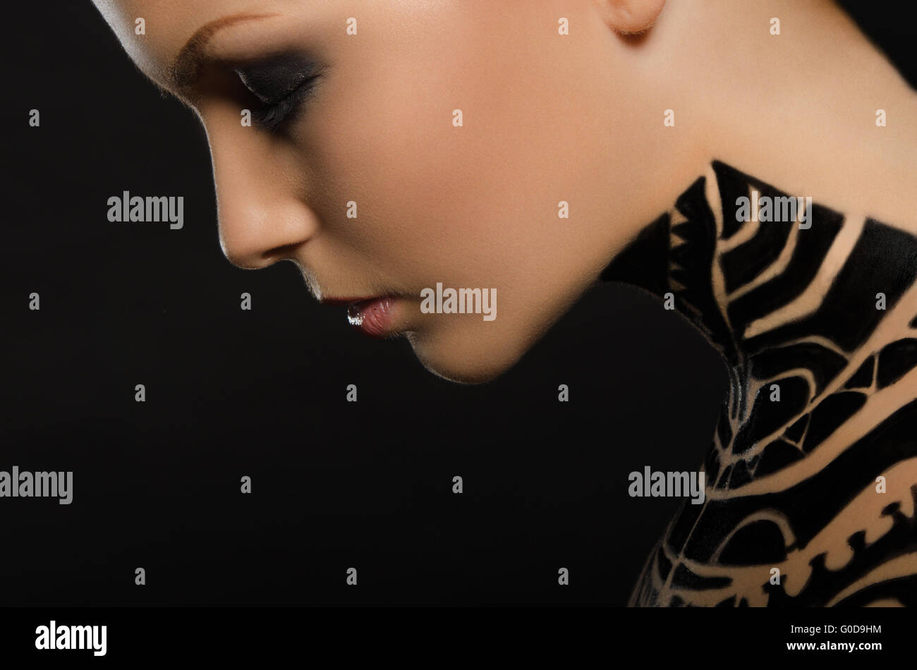 Portrait of beautiful young woman, black body art Stock Photo - Alamy