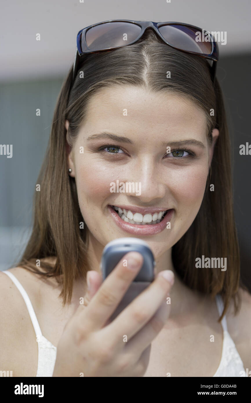 Happy young woman with mobile phone Stock Photo - Alamy