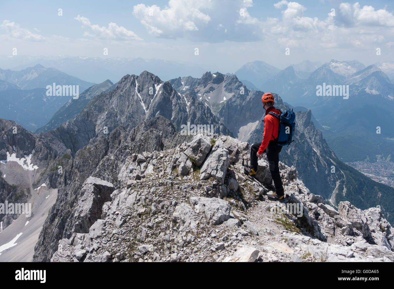 Alpinist at high mountain range Stock Photo - Alamy