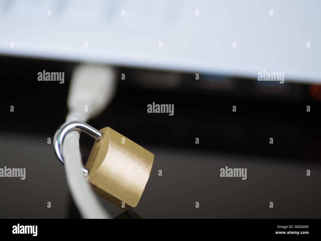 Laptop locked cable lock hi-res stock photography and images - Alamy