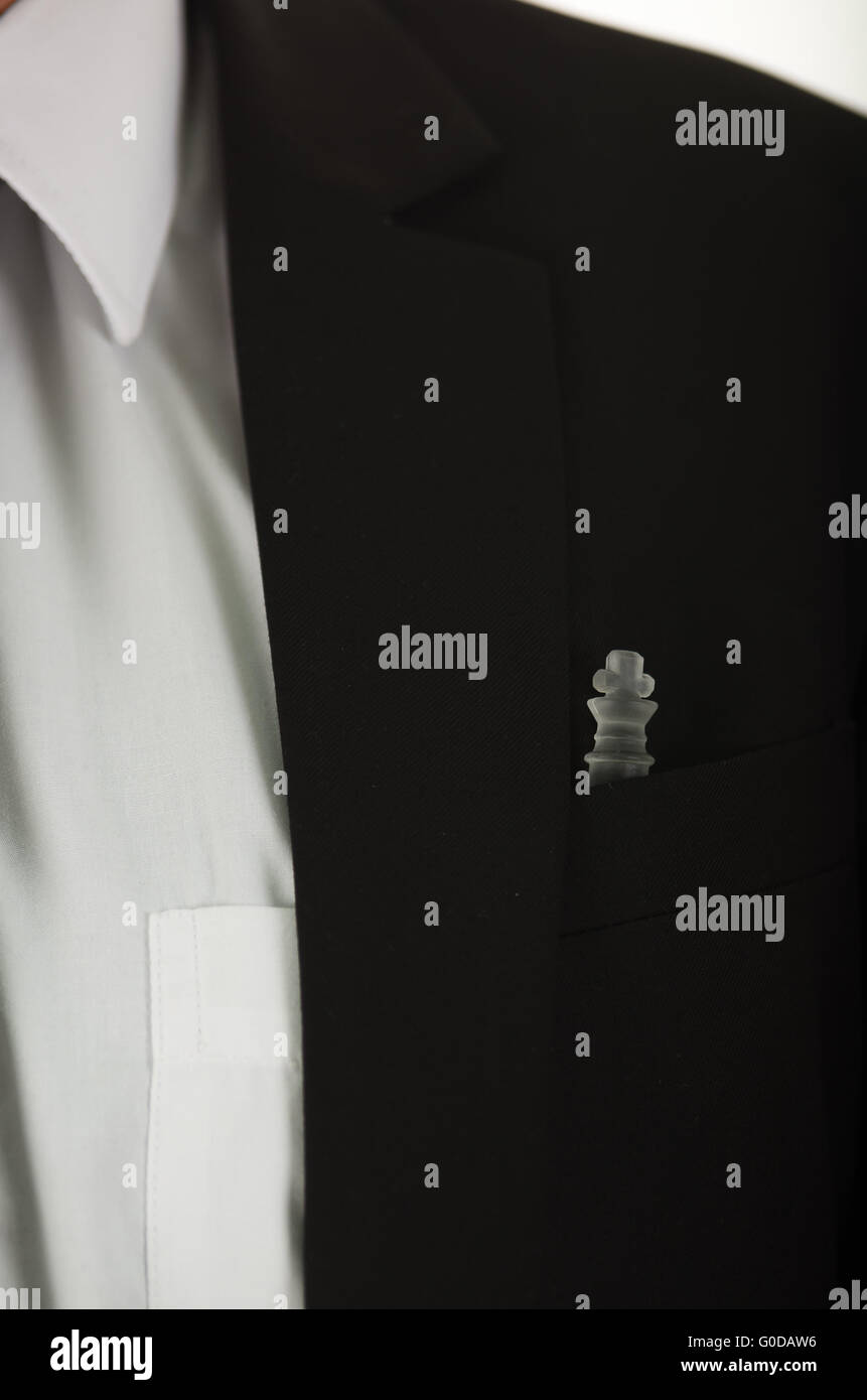 Closeup black suit jacket chest pocket with glass chess piece sitting ...