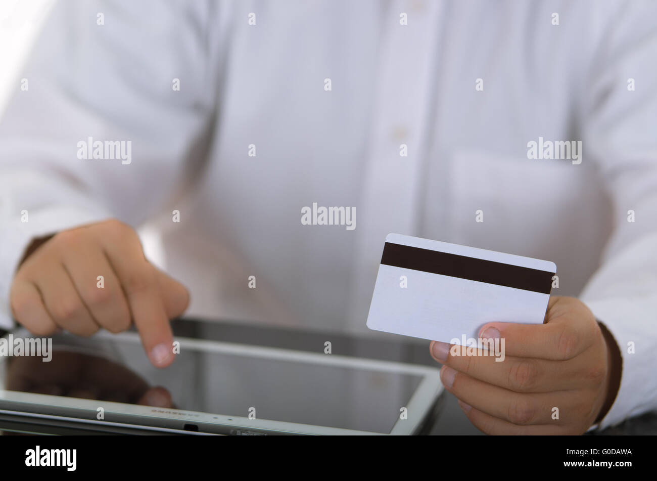 Closeup man holding white electronic swipe card and pressing tablet ...