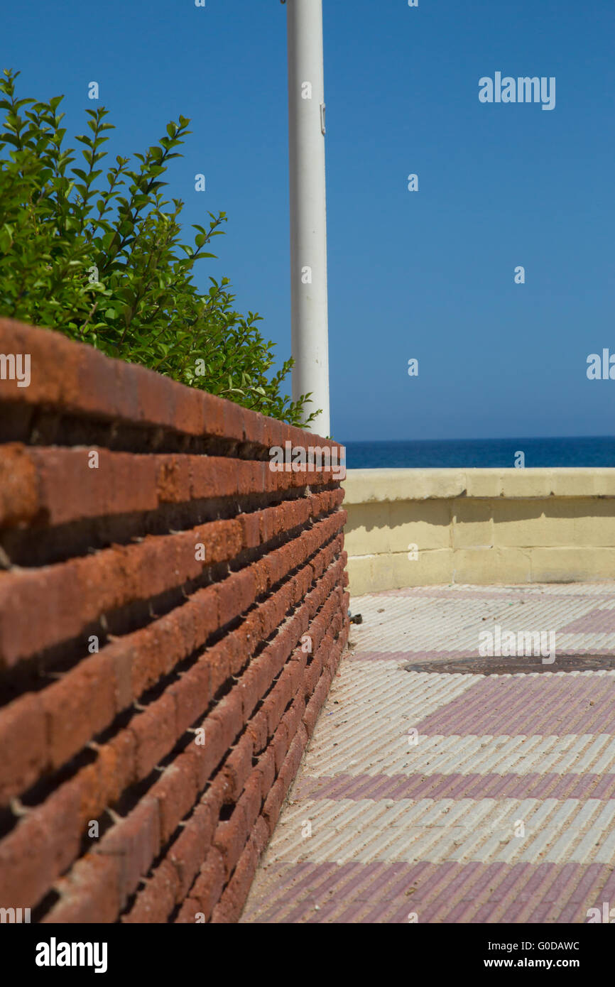 Promenade on the Mediterranean with brick wall Stock Photo - Alamy
