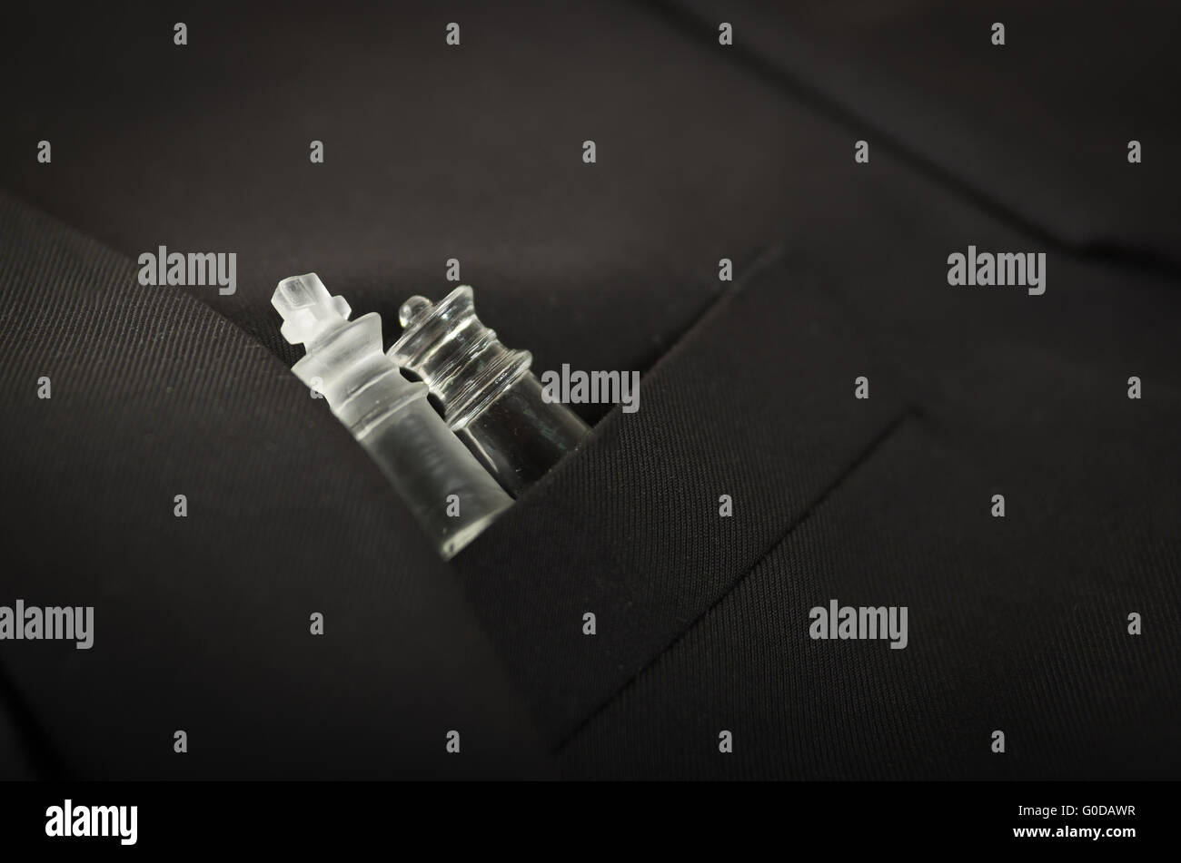 Closeup black suit jacket chest pocket with glass chess piece sitting ...