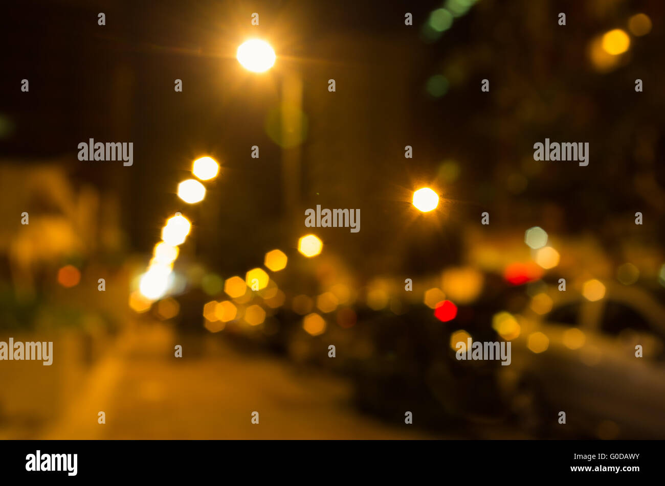 Blurry yellow evening lights as seen through abstract artistic point of ...