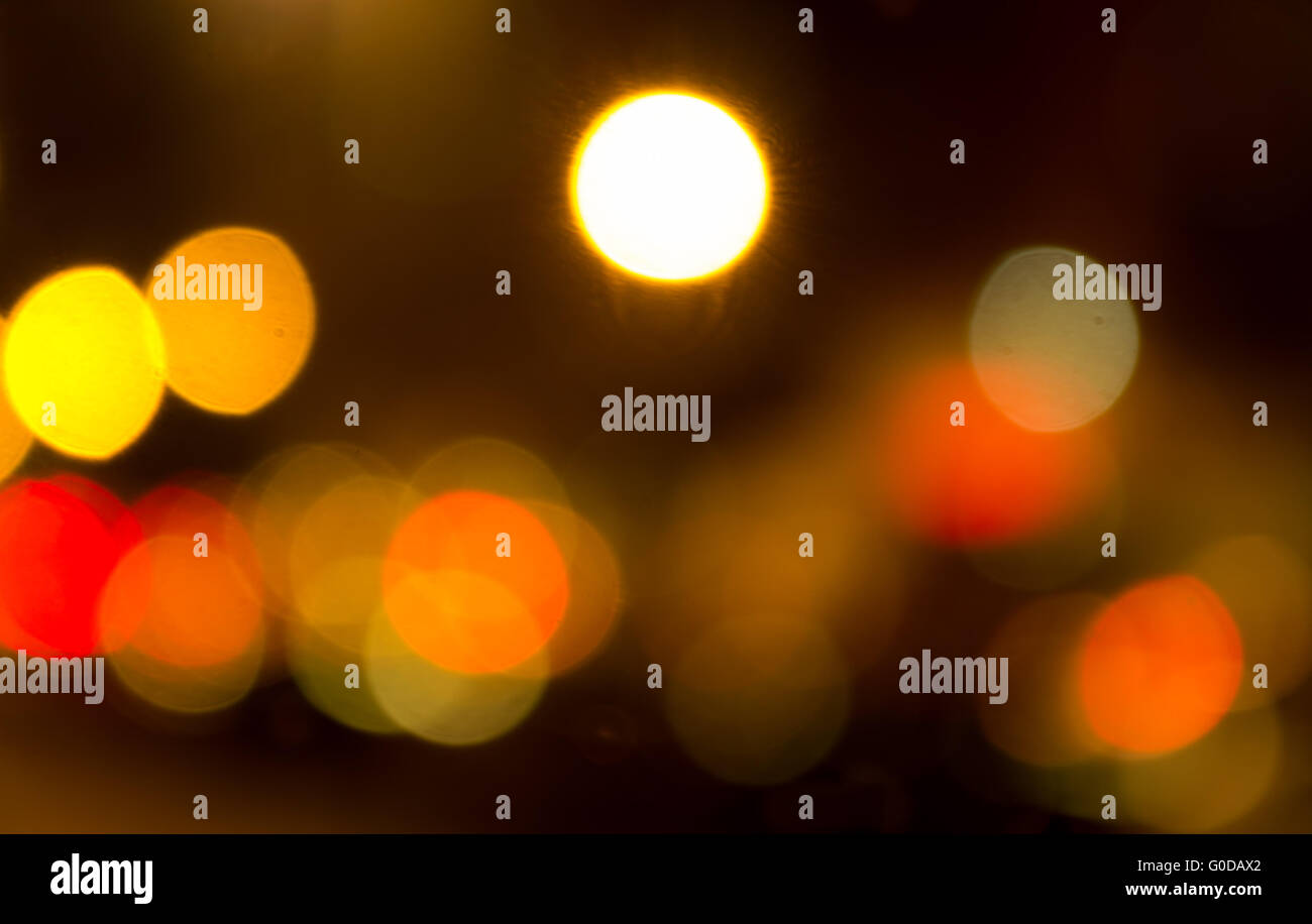 Blurry yellow evening lights as seen through abstract artistic point of ...