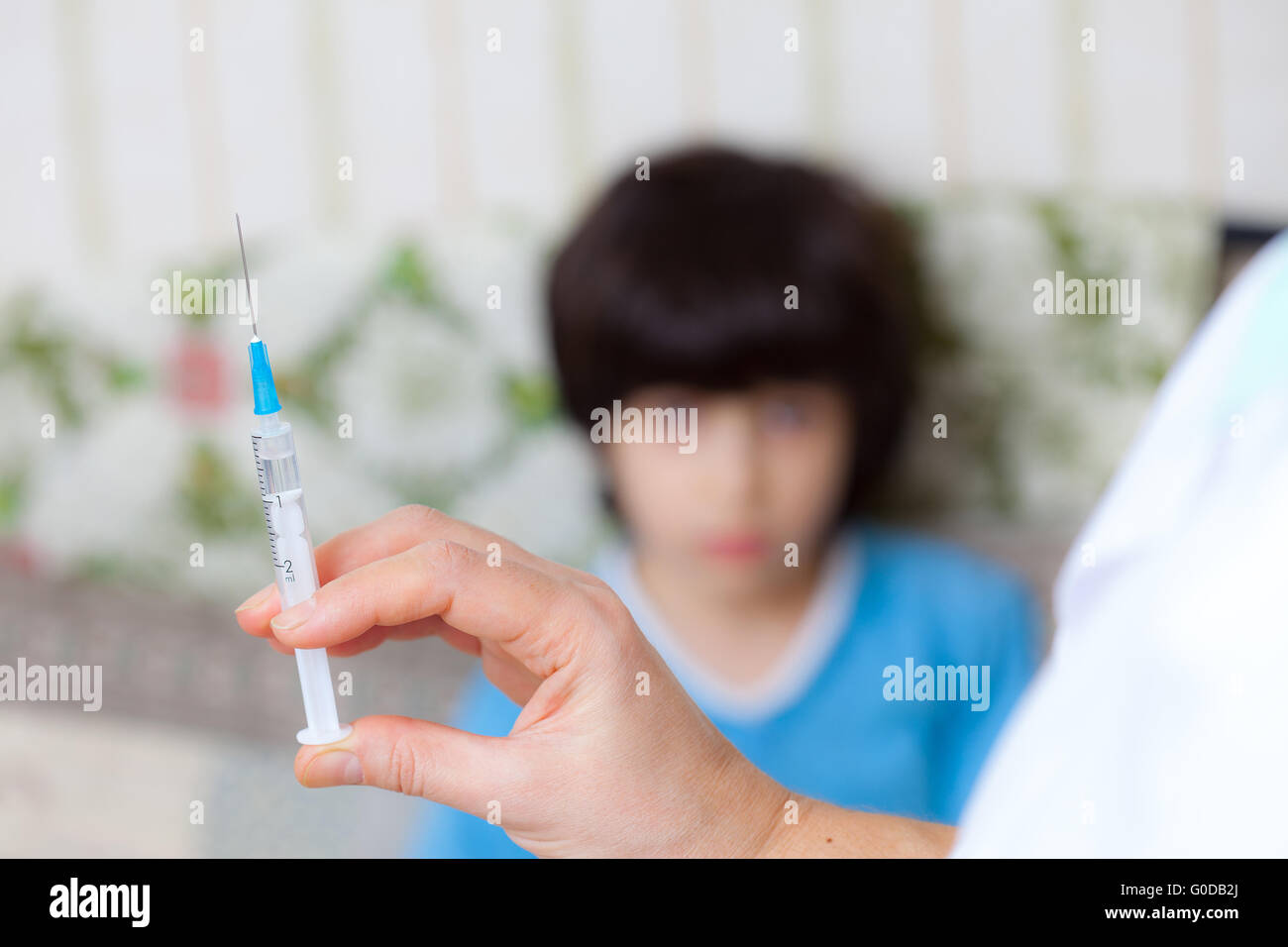 Doctor pediatrician with a syringe and a child in Stock Photo - Alamy