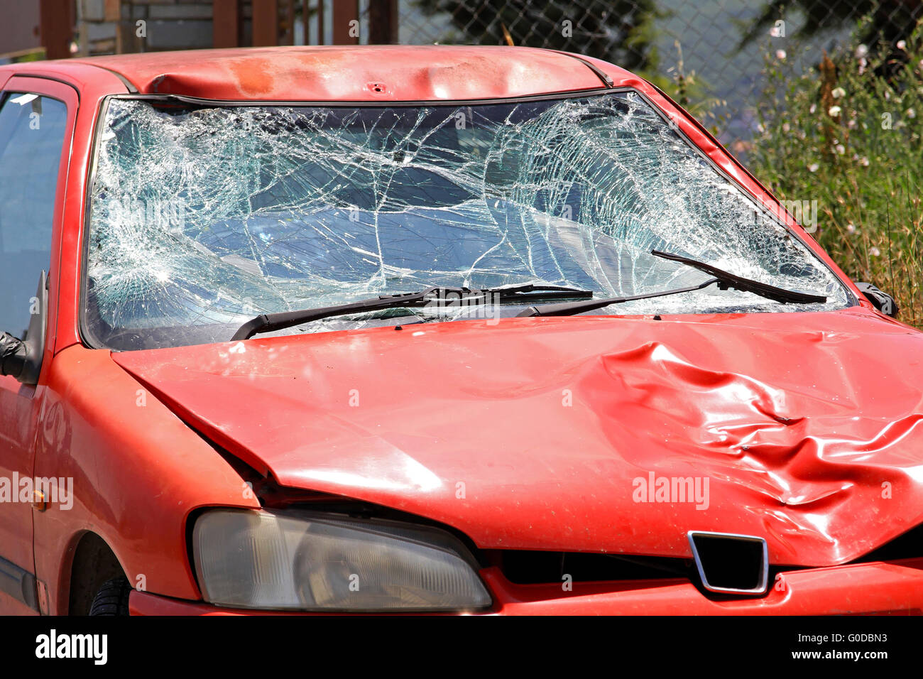 Broken windscreen at red car in traffic accident Stock Photo - Alamy