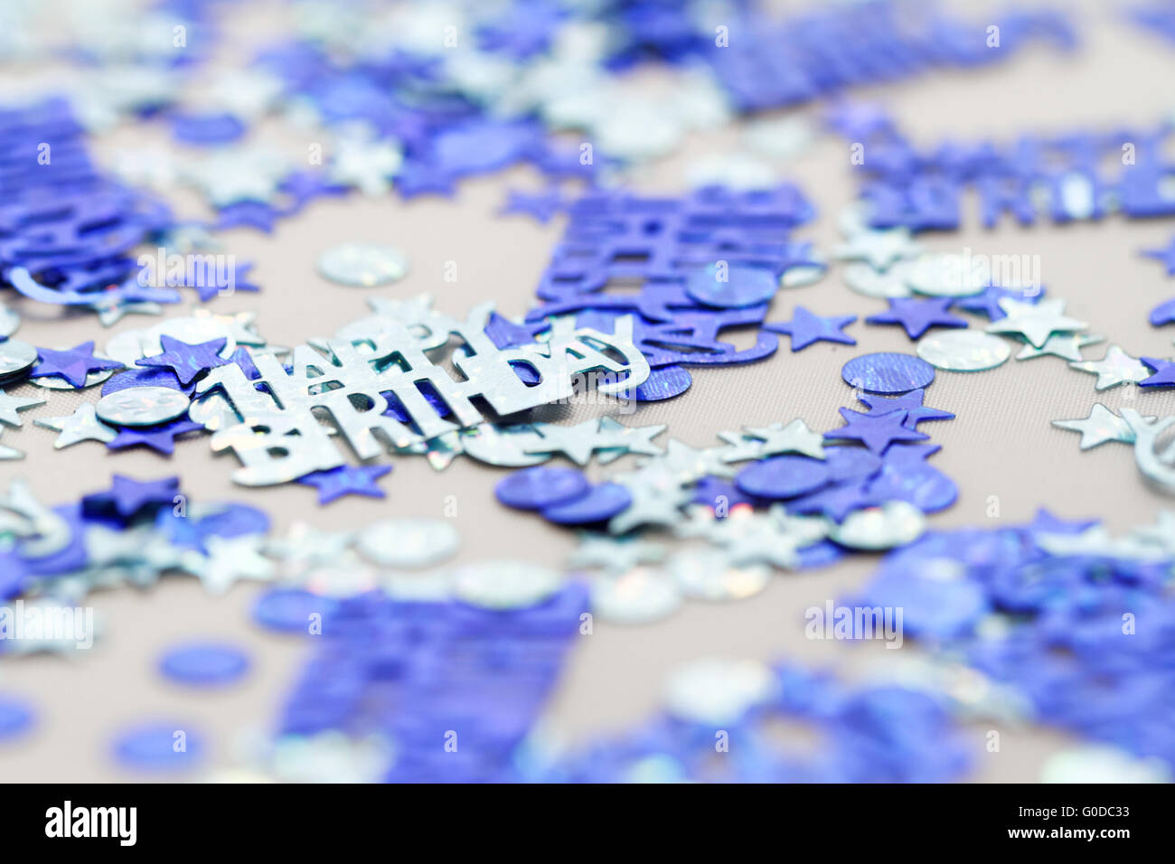 Blue happy birthday confetti pieces - macro photo Stock Photo - Alamy