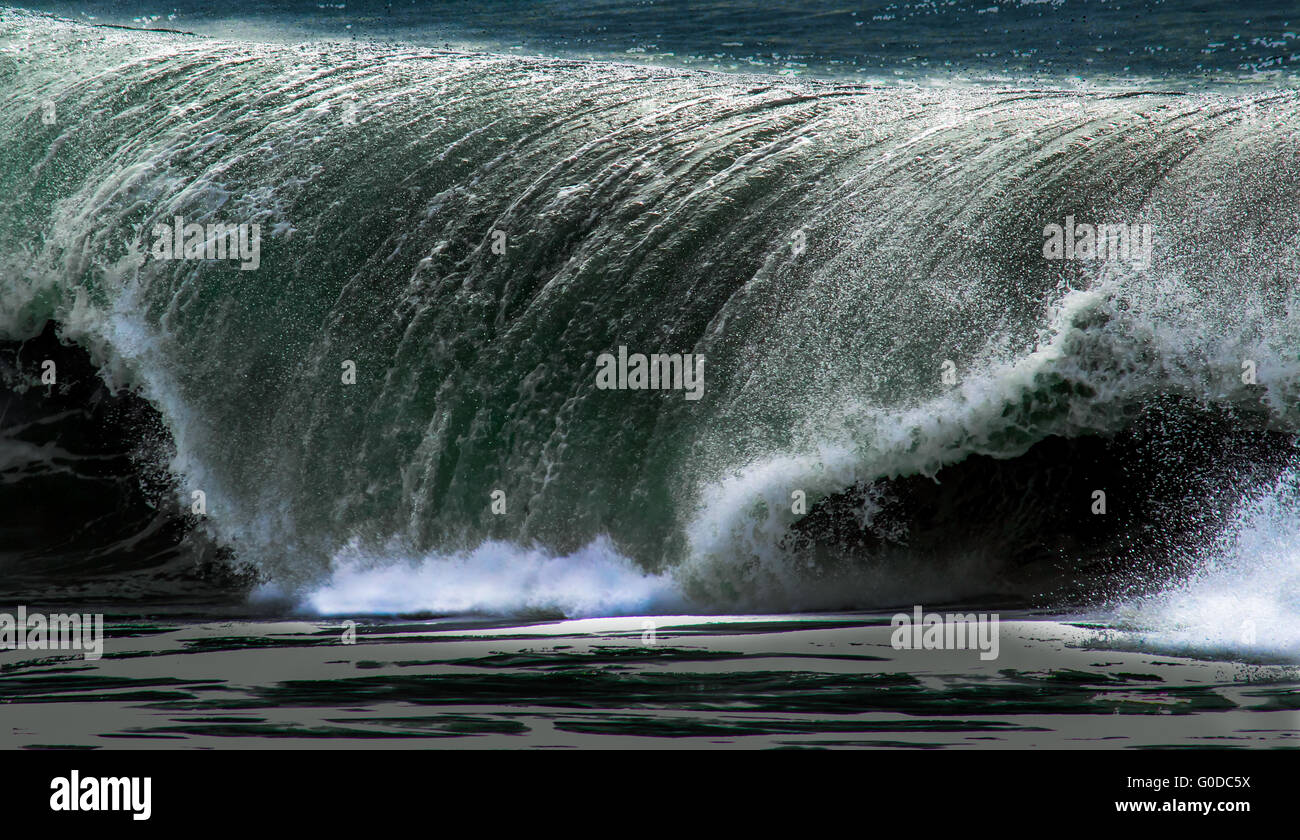 A big wave crashes on the beach Stock Photo - Alamy