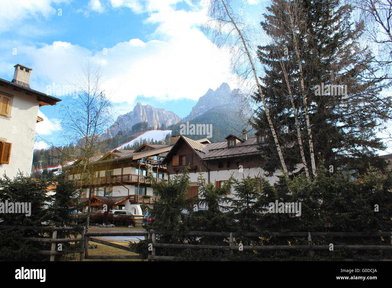 The Italian Dolomites behind chalet style hotels and buildings in the ...