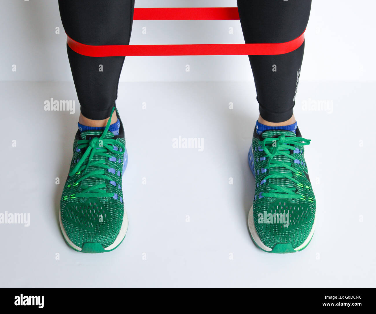 Young Woman resistance loop training on a white background Stock Photo ...