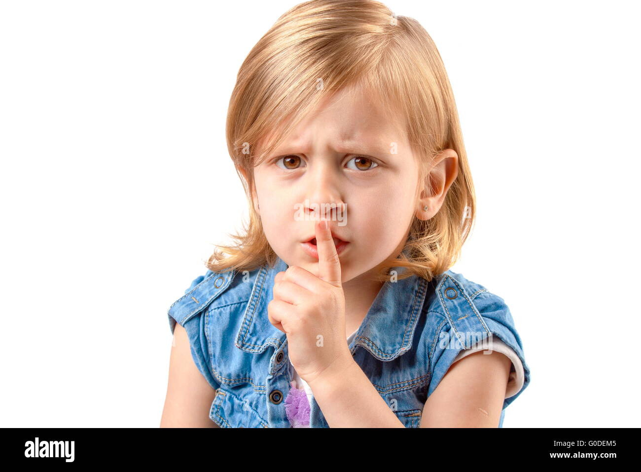 Cute girl making hush sign Stock Photo - Alamy