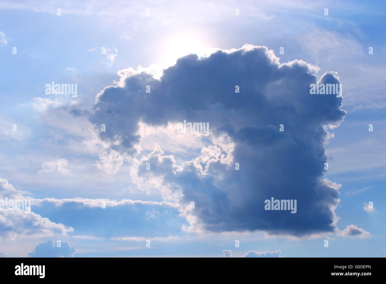 cloud with unusual shape and sunny beams Stock Photo - Alamy