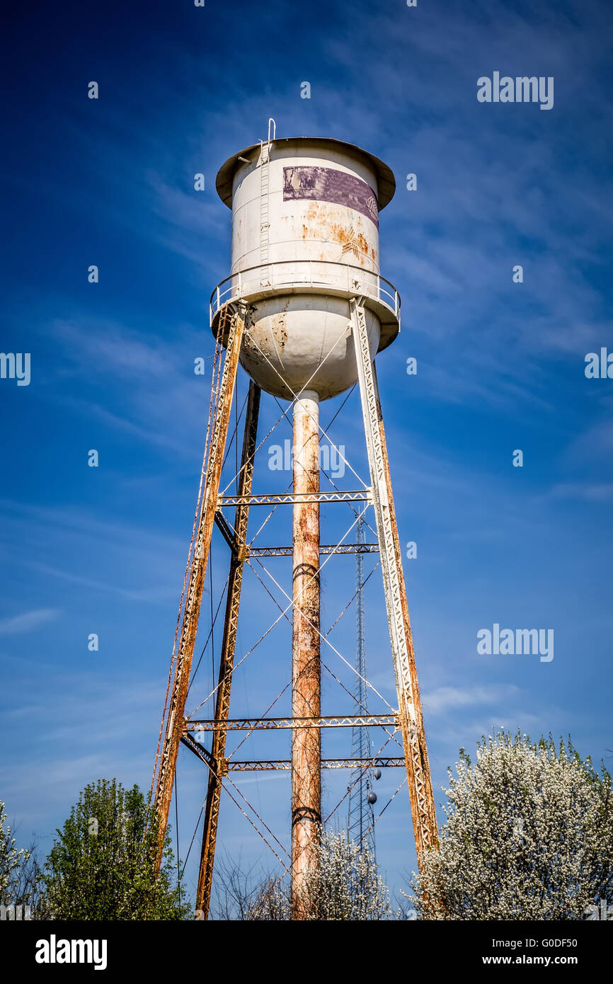 Tall water tower with cloudy blue sky background Stock Photo - Alamy