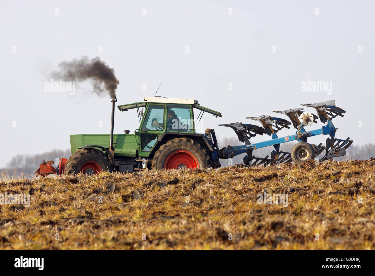 Tractor while plowing Stock Photo - Alamy