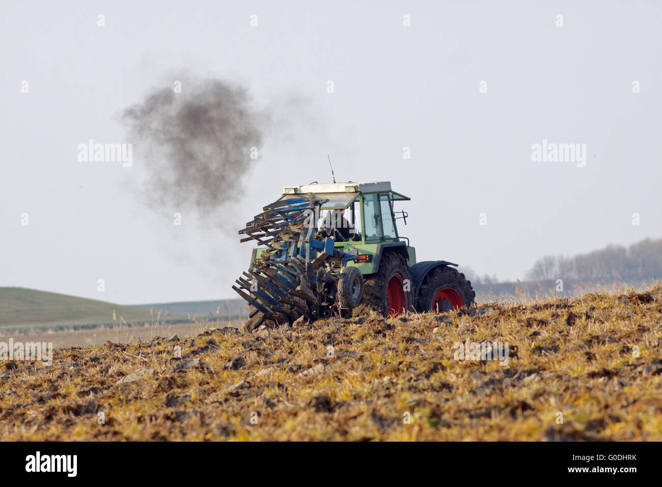 Tractor while plowing Stock Photo - Alamy