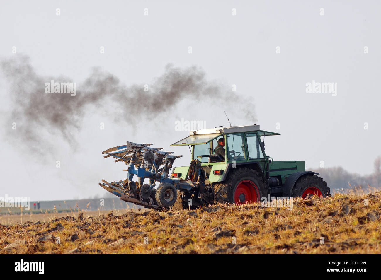 Tractor while plowing Stock Photo - Alamy