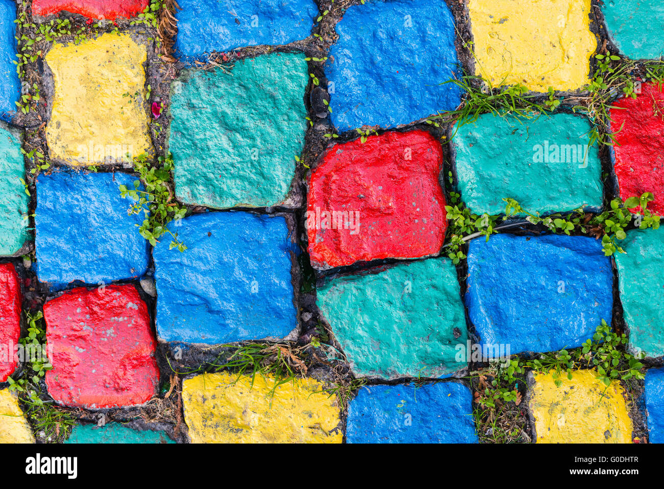 Old painted cobblestone background with grass Stock Photo - Alamy