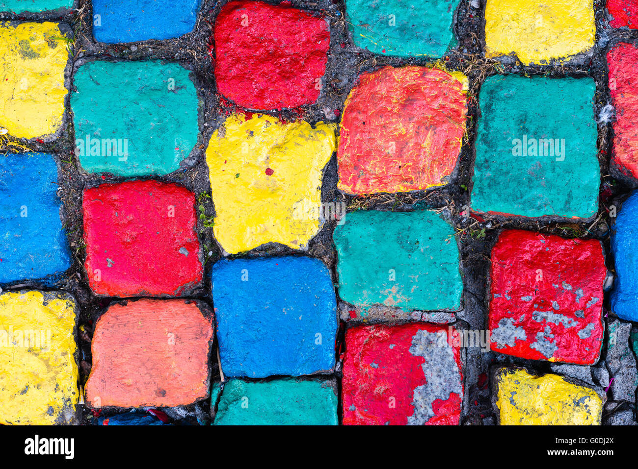 Old painted cobblestone background with grass Stock Photo - Alamy