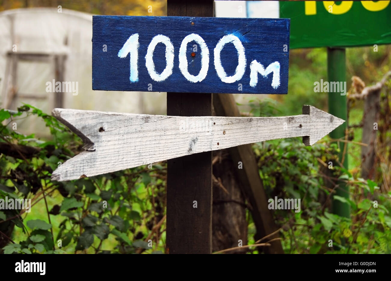 Rustic wooden road direction sign Stock Photo - Alamy