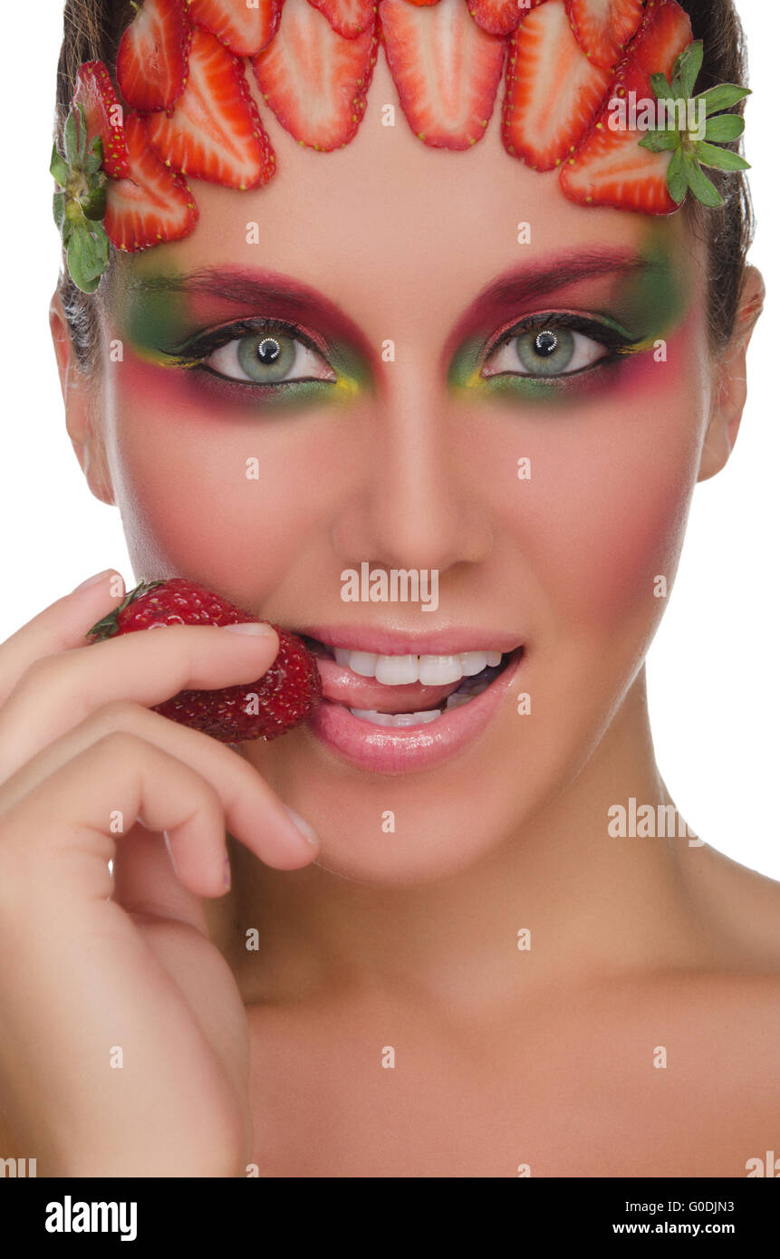 Beautiful woman with strawberries on face and hand Stock Photo - Alamy