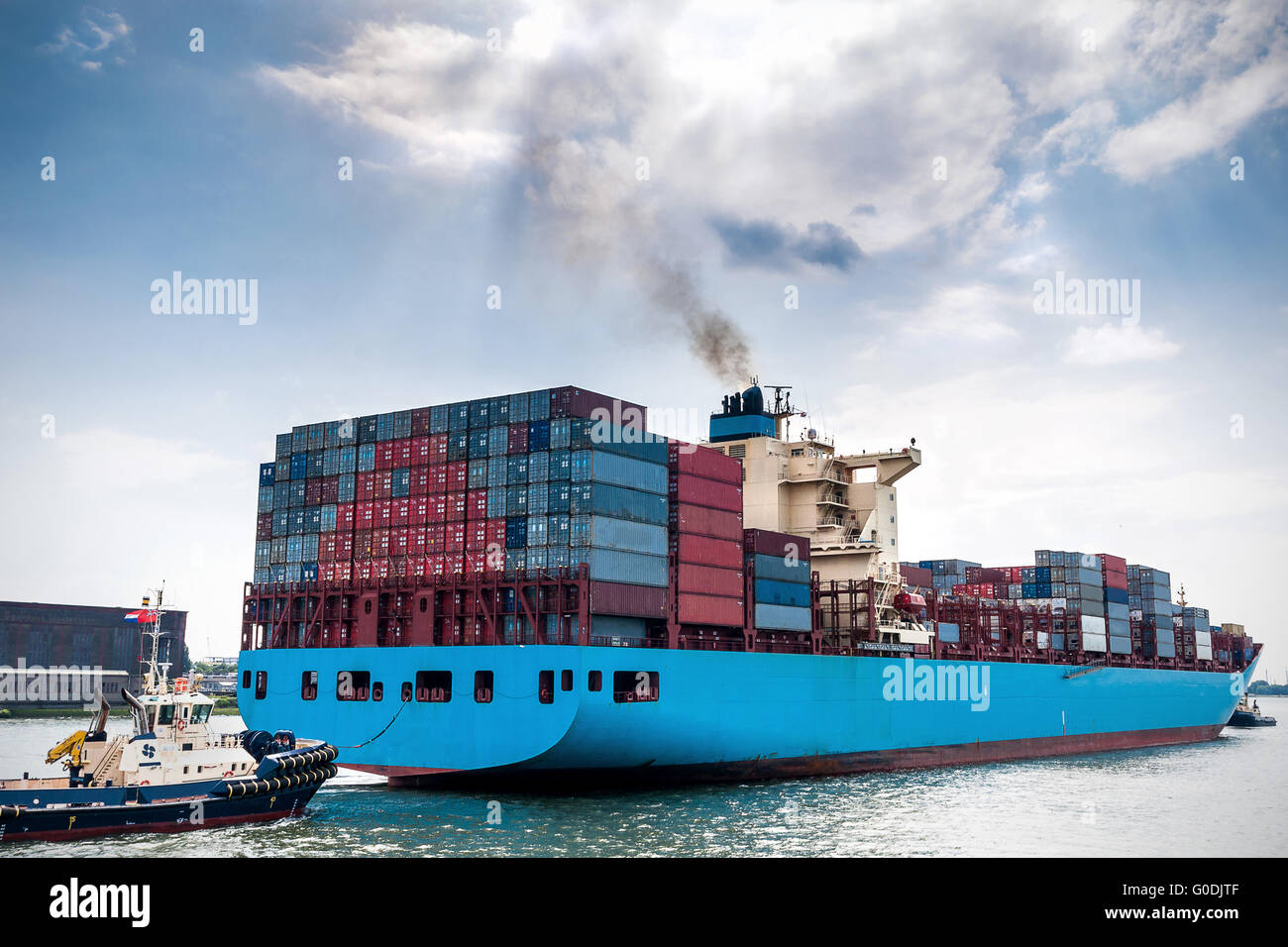 2 tug vessels pulling a loaded container ship from Stock Photo - Alamy