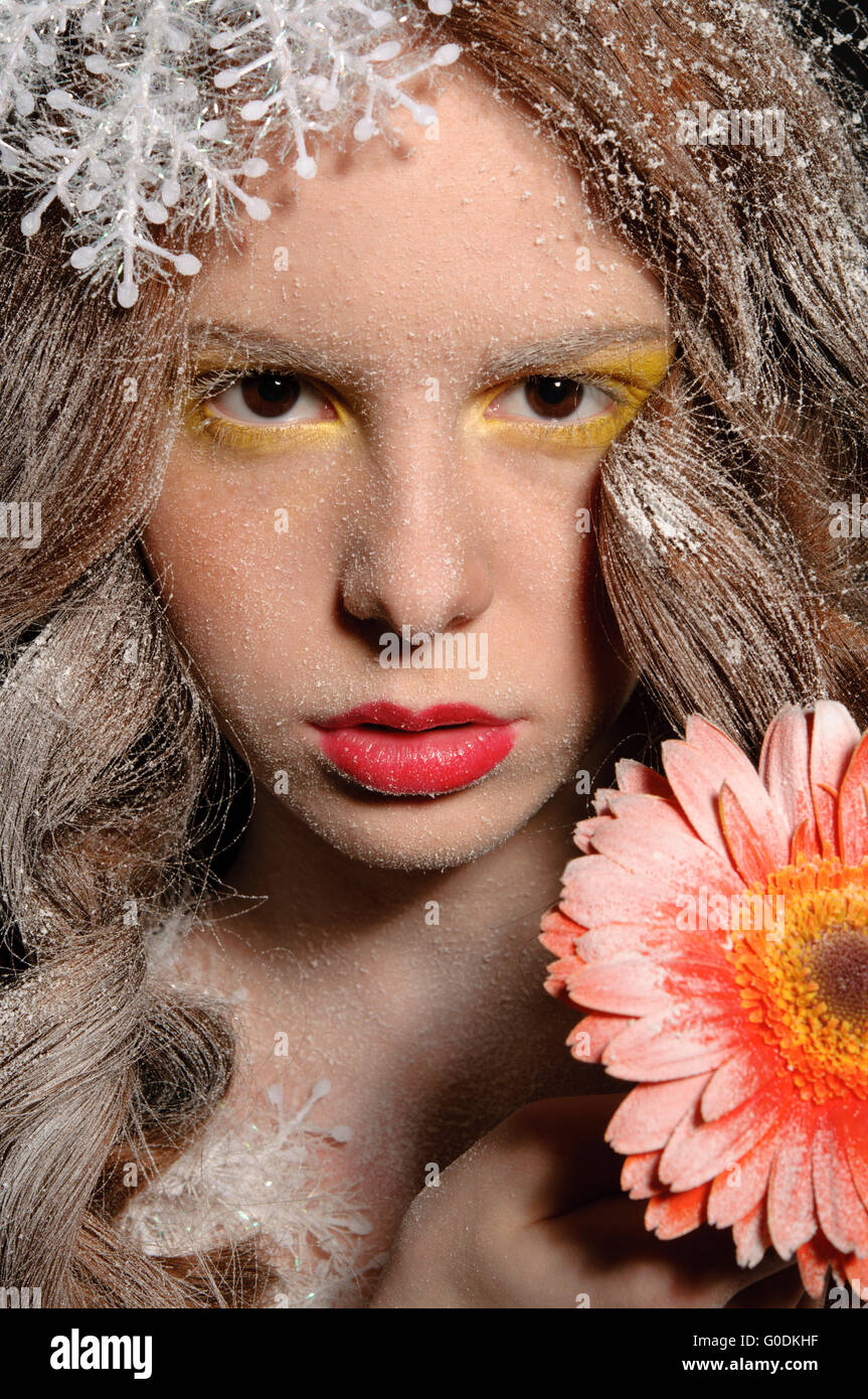 girl with flower in his hand under falling snow Stock Photo - Alamy