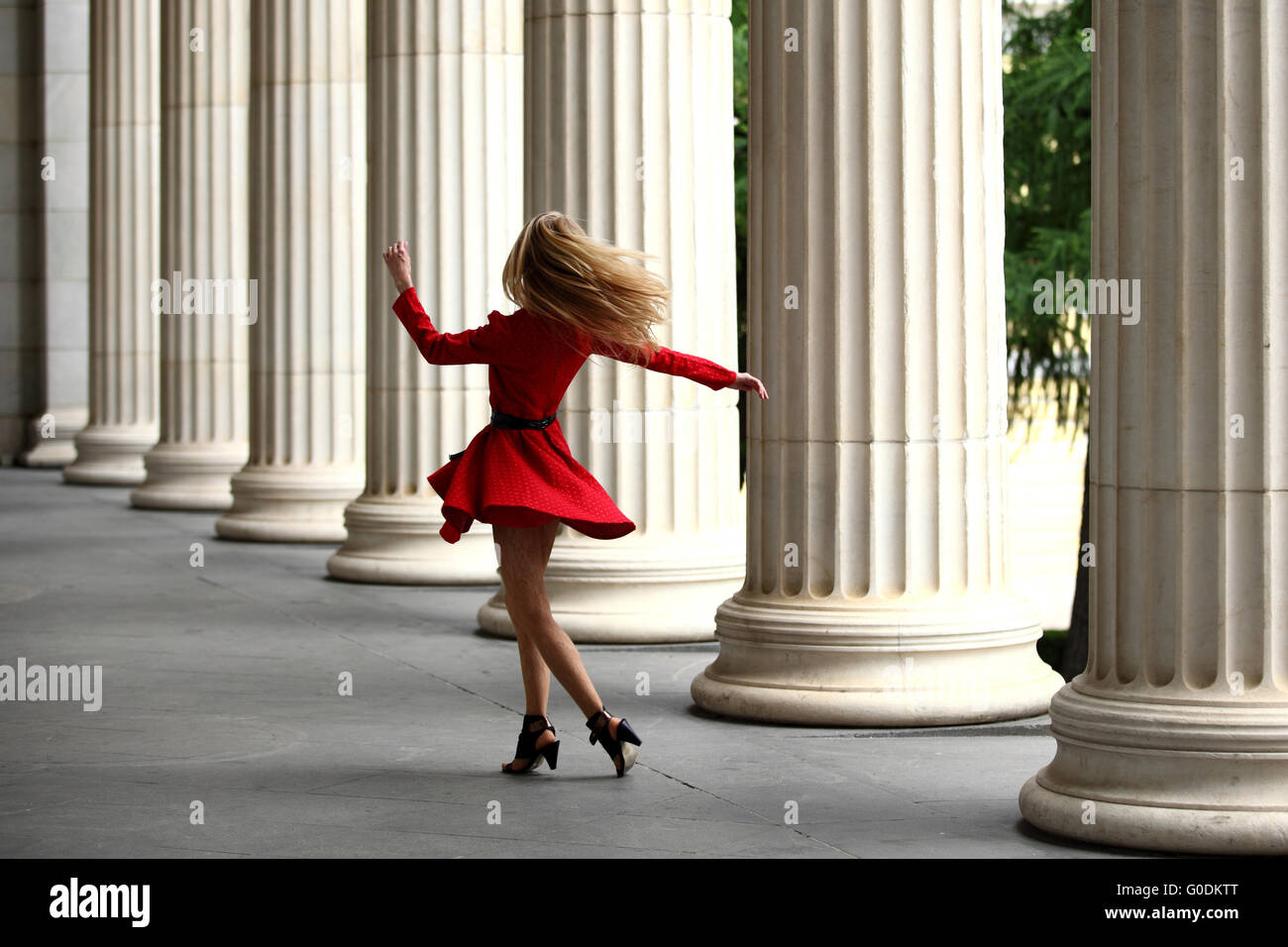 Young woman dancing trough some ancient columns Stock Photo - Alamy