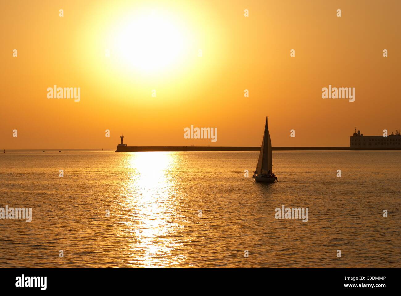 Sail boat against sunset Stock Photo - Alamy