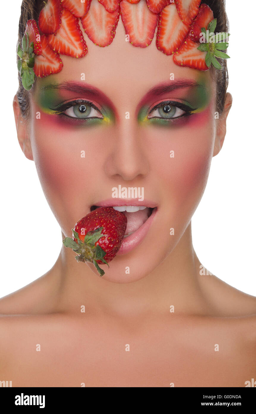 Beautiful woman, strawberries on face and teeth Stock Photo - Alamy