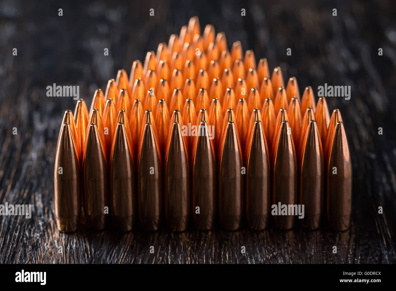 Macro shot of copper bullets that are in many rows to form a triangle ...