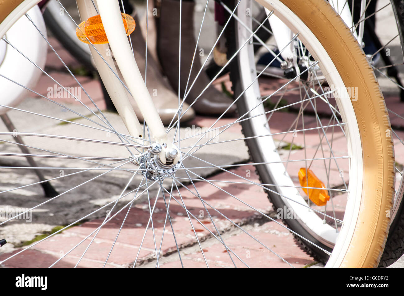 Front bicycle wheels with metal spokes closeup Stock Photo - Alamy