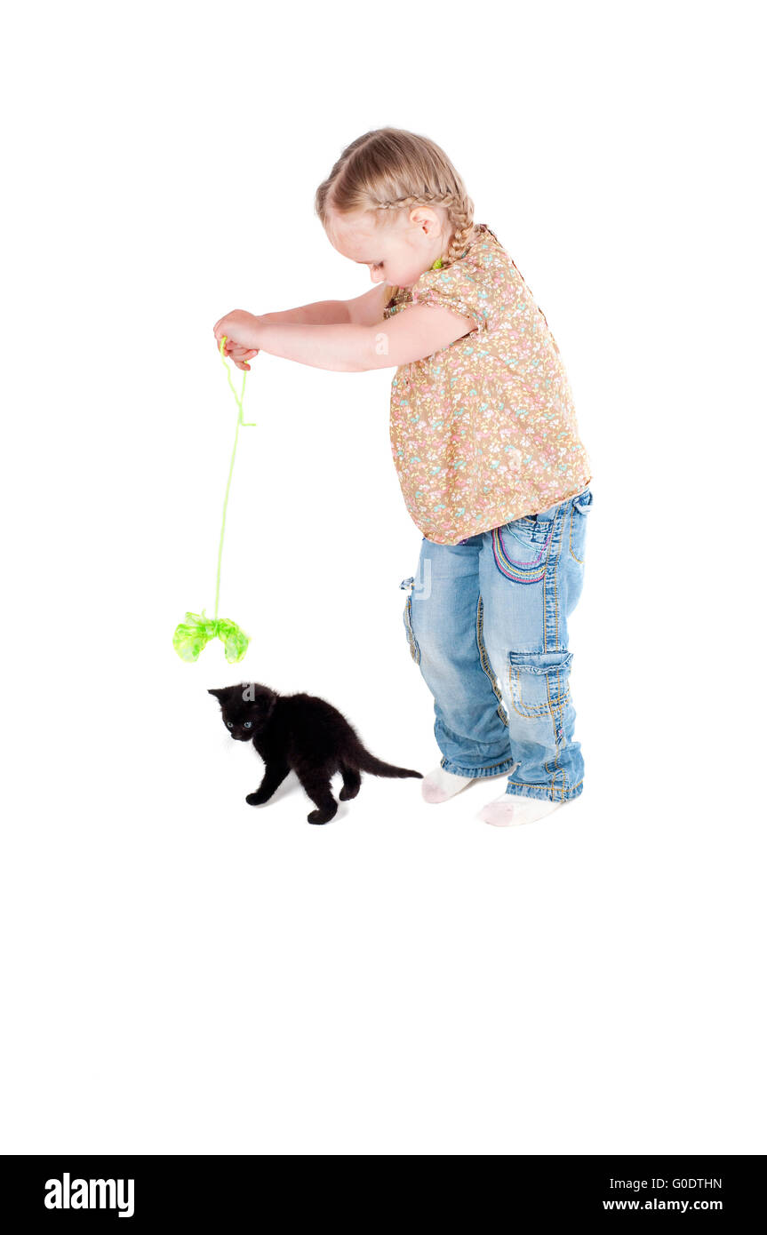 Happy kid girl playing with black cat kitten Stock Photo - Alamy