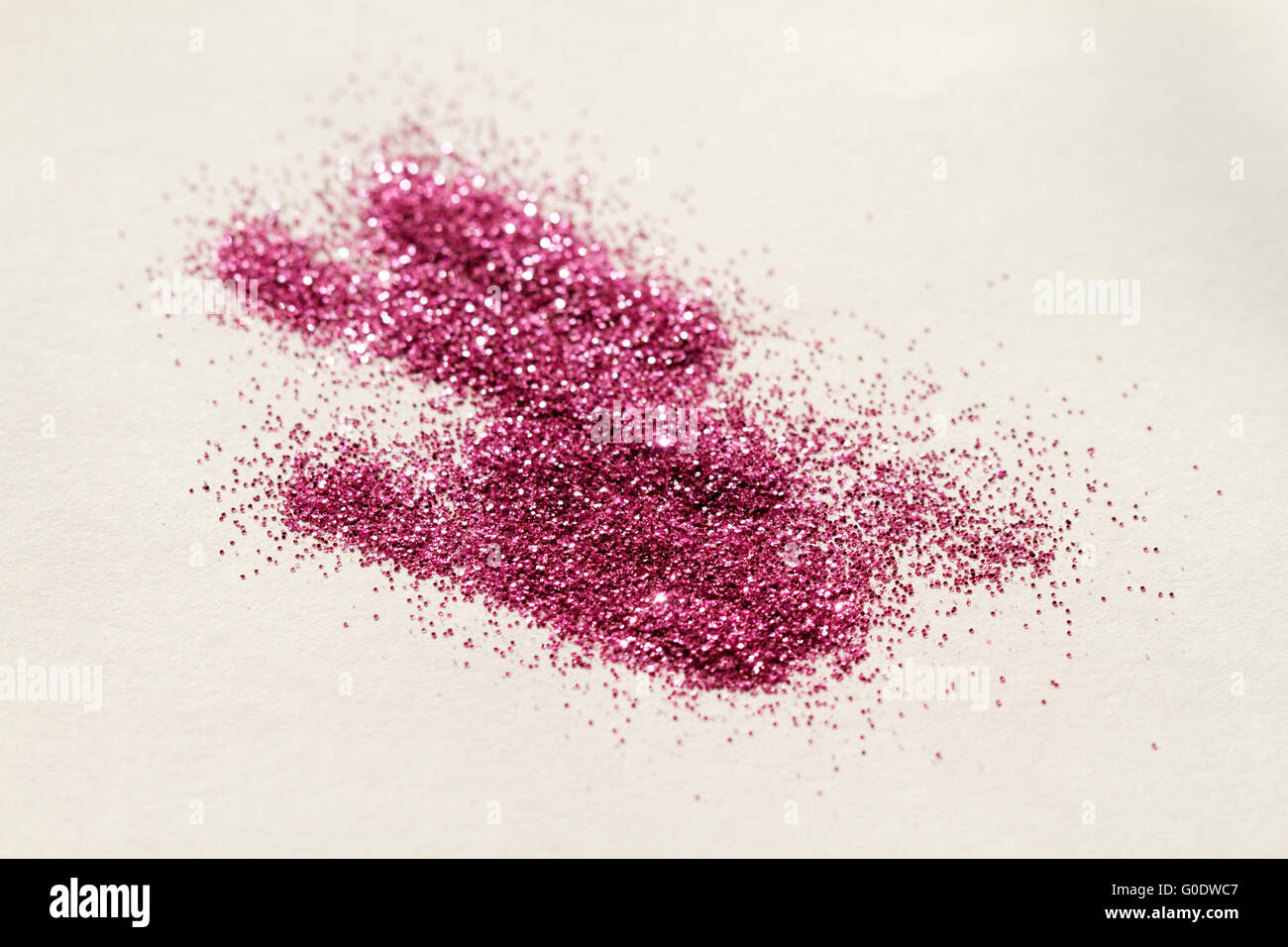 Magenta glitter on light background - macro photo Stock Photo - Alamy
