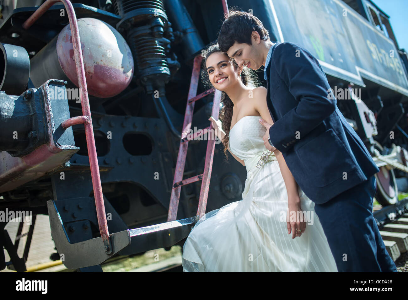 Portrait of happy wedding couple near the old steam locomotive Stock ...