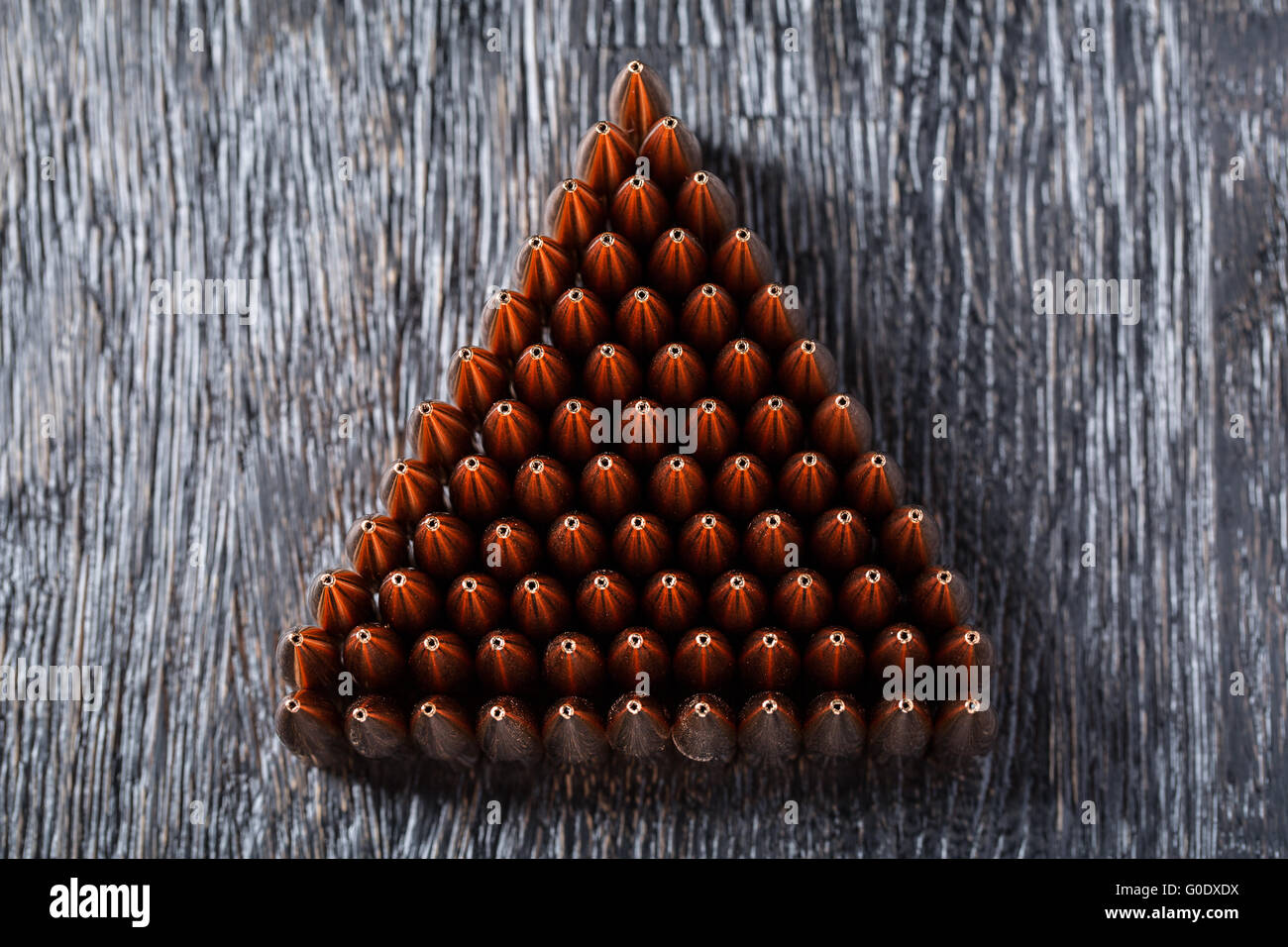 Macro shot of copper bullets that are in many rows to form a triangle ...